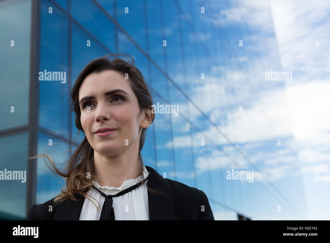 Young female executive standing in office premises Stock Photo - Alamy