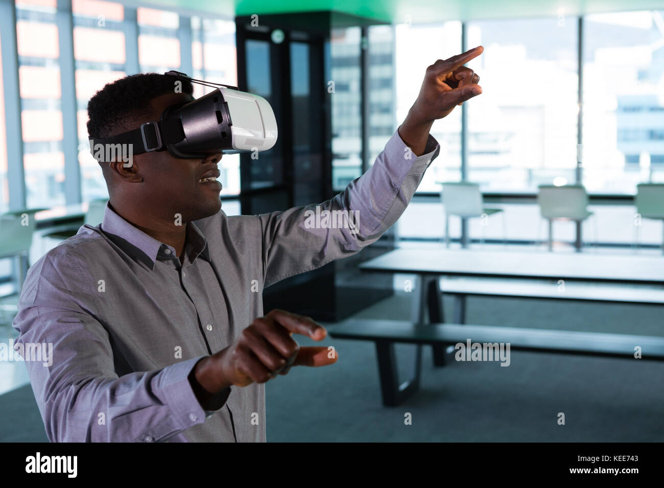 Man using virtual reality headset in futuristic office Stock Photo - Alamy