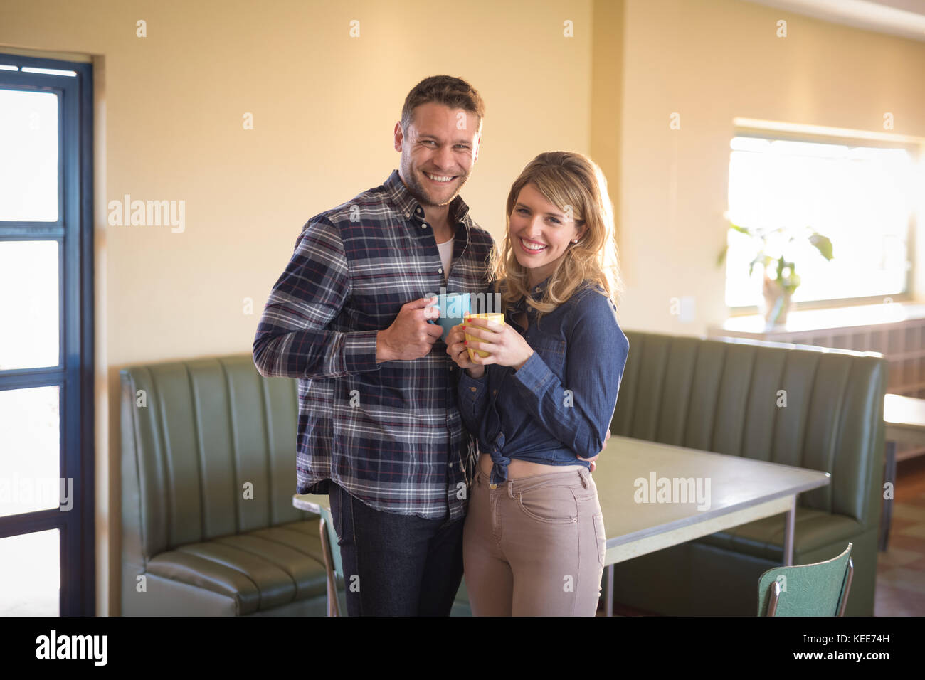 Happy couple having coffee in restaurant Stock Photo - Alamy