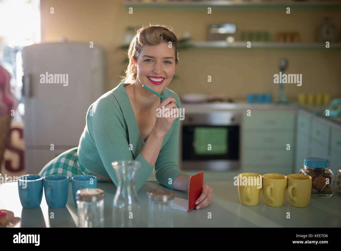 Portrait of waitress standing in restaurant Stock Photo - Alamy
