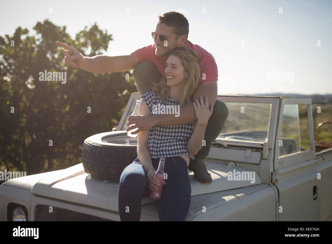 Young woman sitting on car bonnet hi-res stock photography and images ...