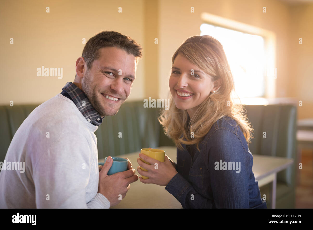 Happy couple having coffee in restaurant Stock Photo - Alamy