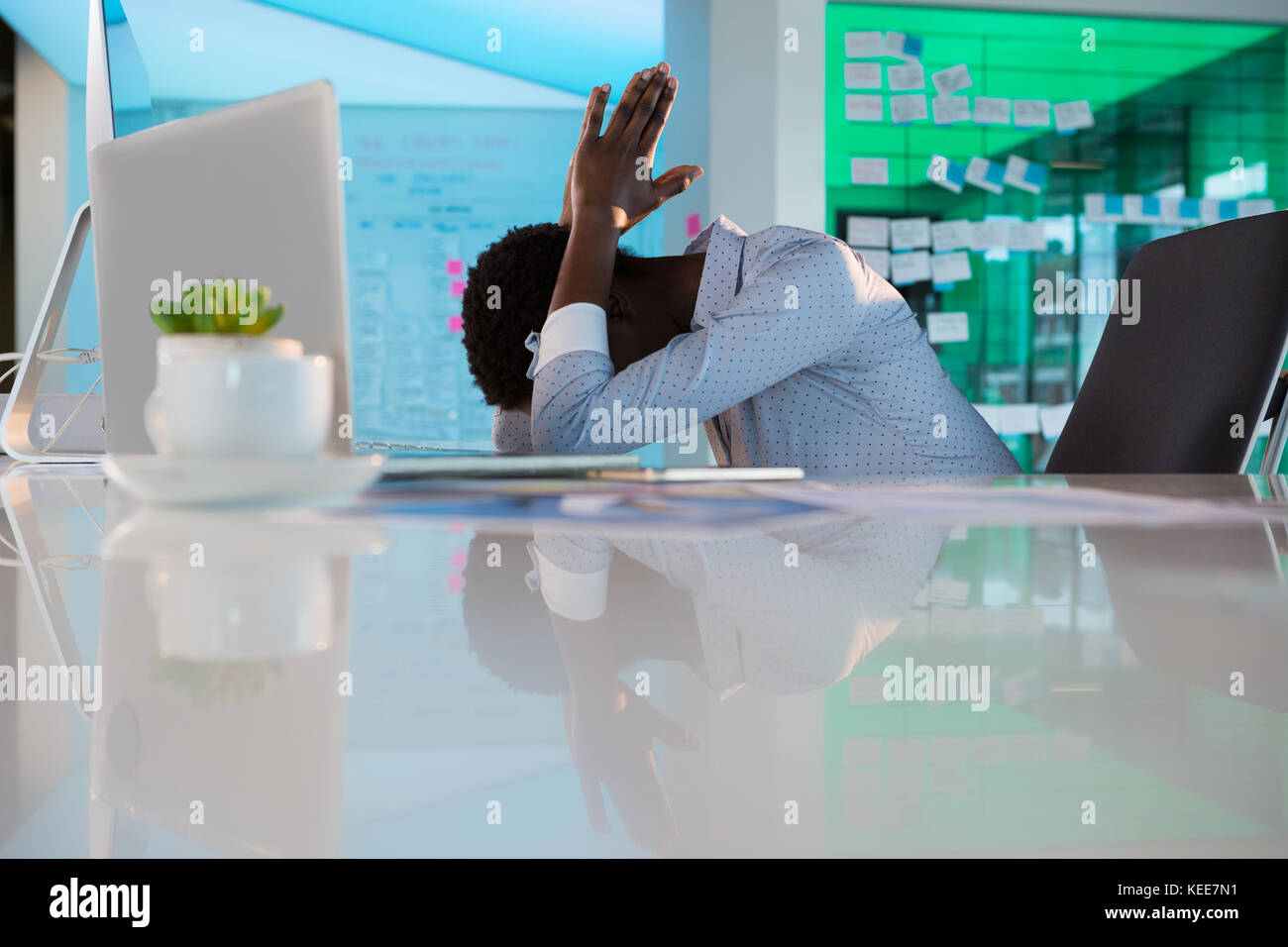 Frustrated female executive sitting in futuristic office Stock Photo ...