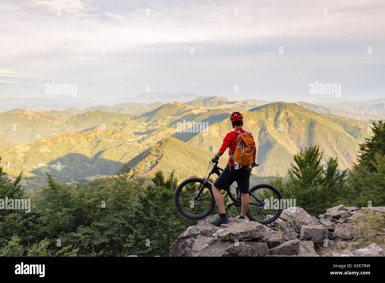 Mountain biker looking at inspiring landscape on bike rocky trail in ...