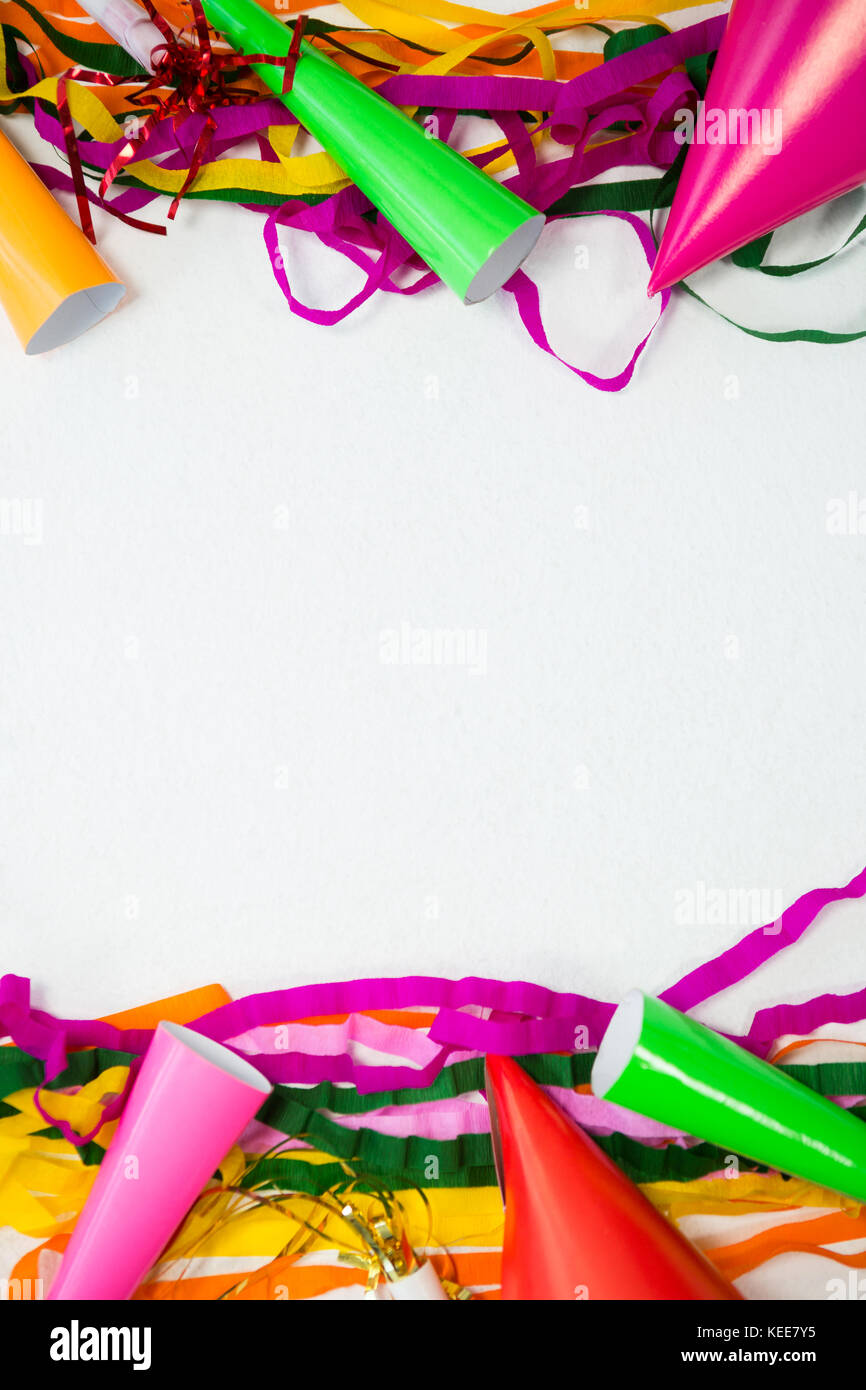 Overhead of colorful streamers and party hat on white background Stock ...