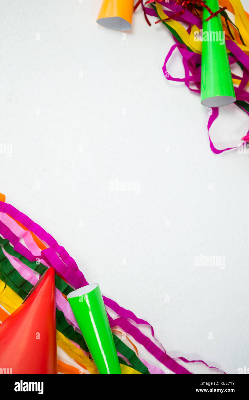 Overhead of colorful streamers and party hat on white background Stock ...