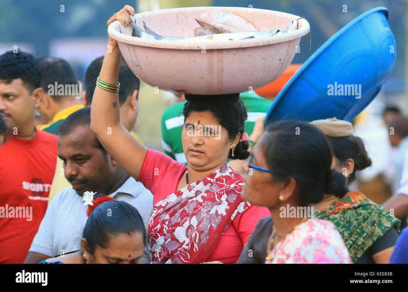 woman carrying fish on sassoon dock Stock Photo - Alamy