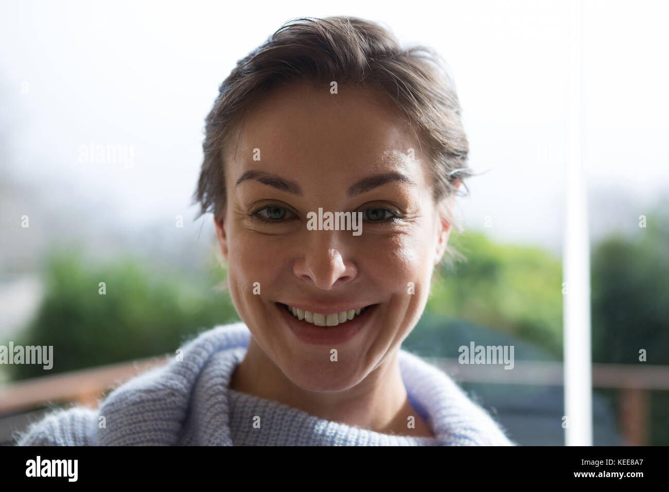 Portrait of smiling woman at home Stock Photo - Alamy