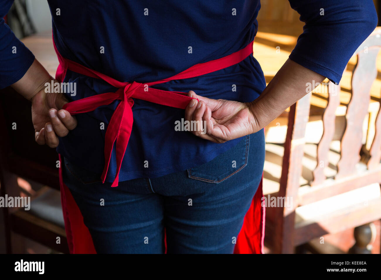 Waitress wearing her apron in the bar Stock Photo - Alamy