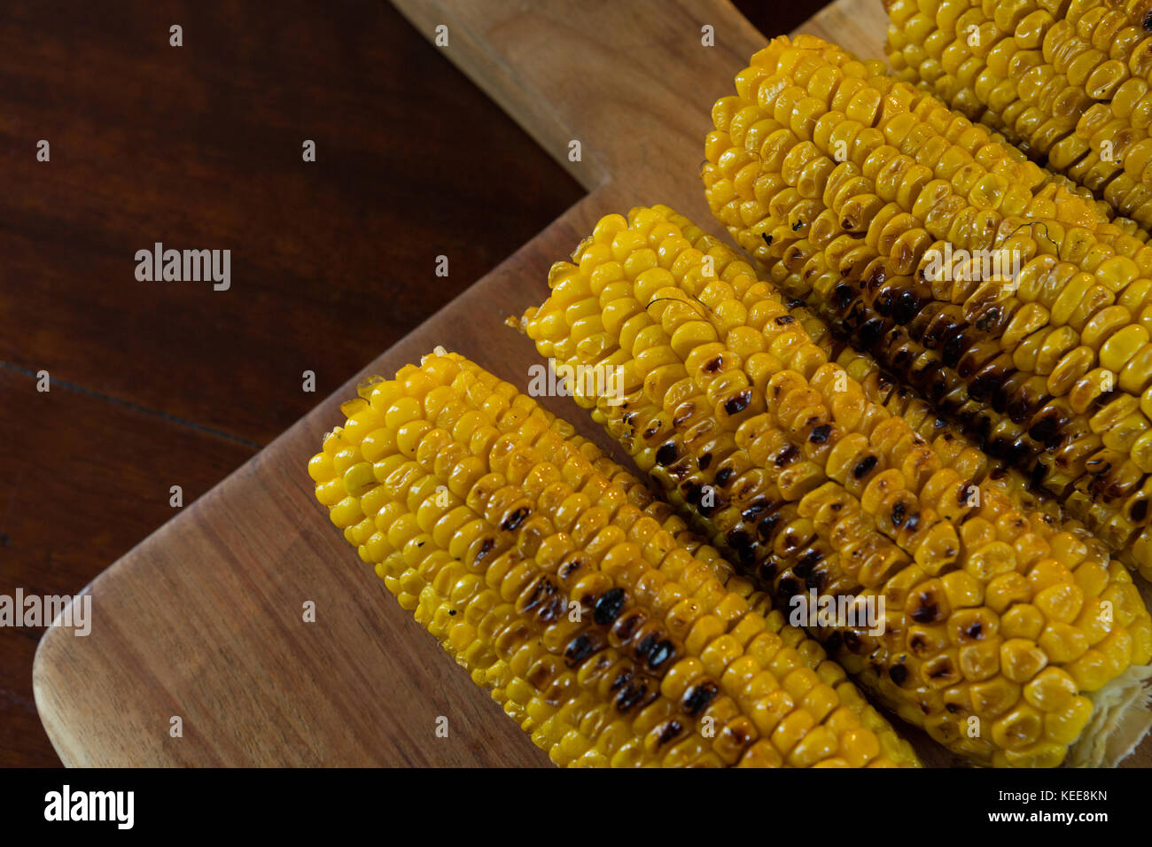 Corn on wooden tray on table Stock Photo - Alamy