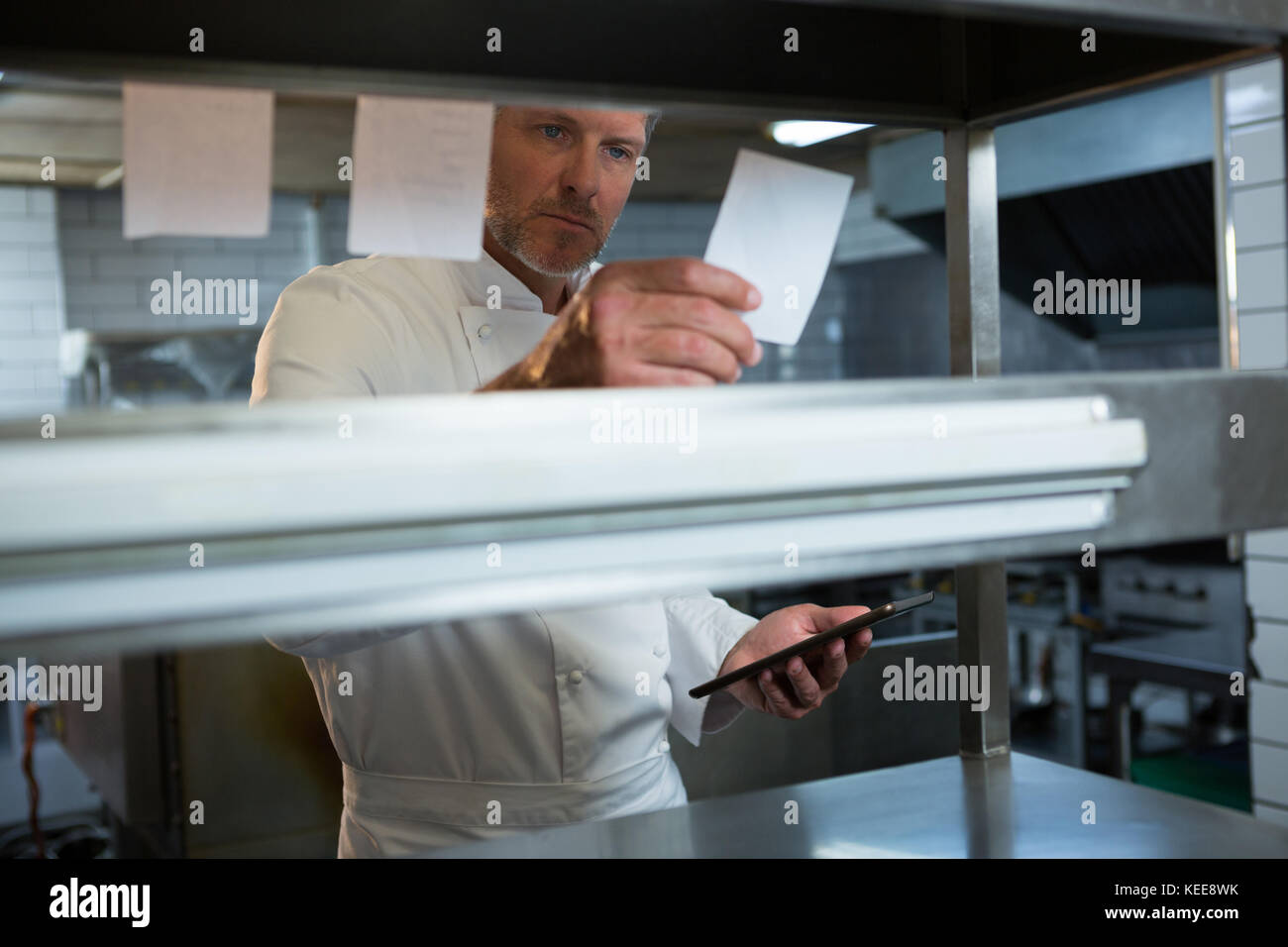 Male chef reading an order in the kitchen Stock Photo - Alamy