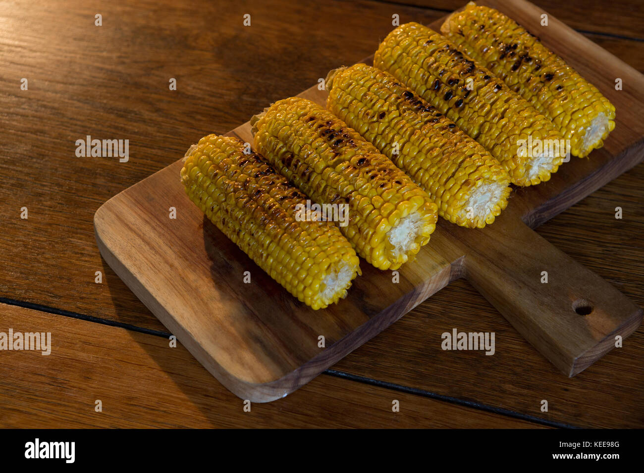 Corn on wooden tray on table Stock Photo - Alamy