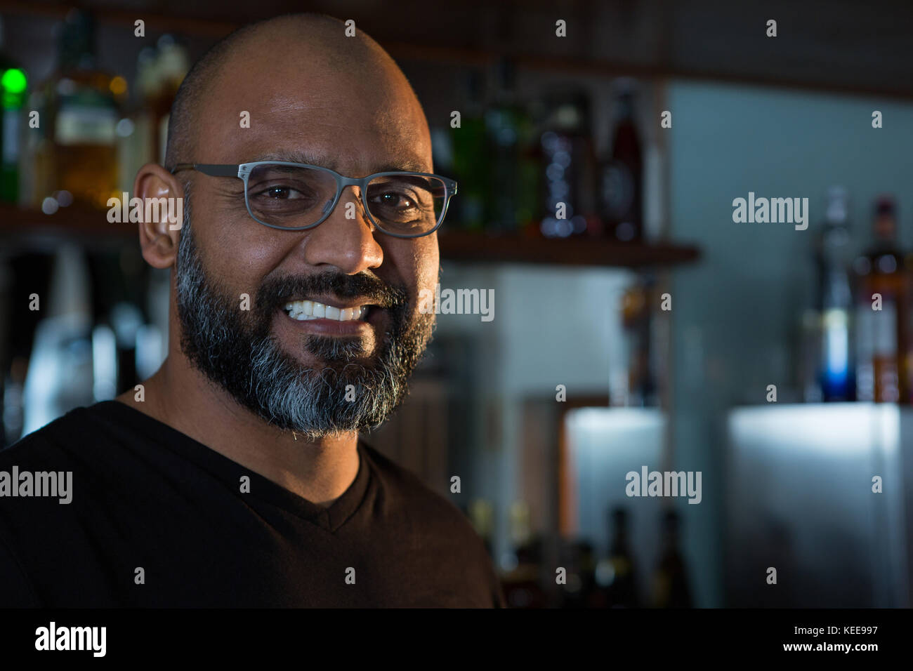 Portrait of man smiling in the bar Stock Photo - Alamy