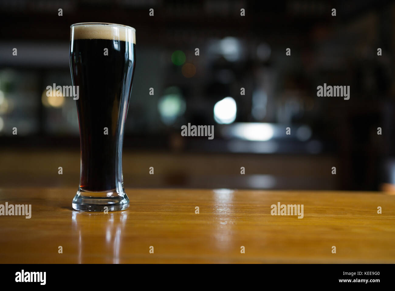 Close-up of beer glass on the counter in bar Stock Photo - Alamy