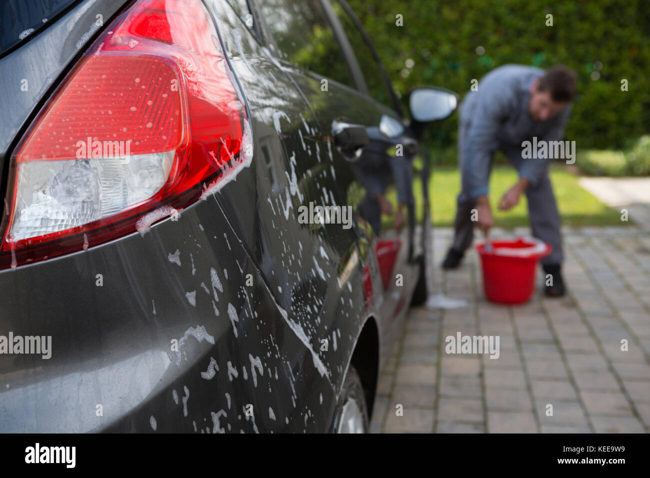 Male auto service staff washing a car Stock Photo - Alamy