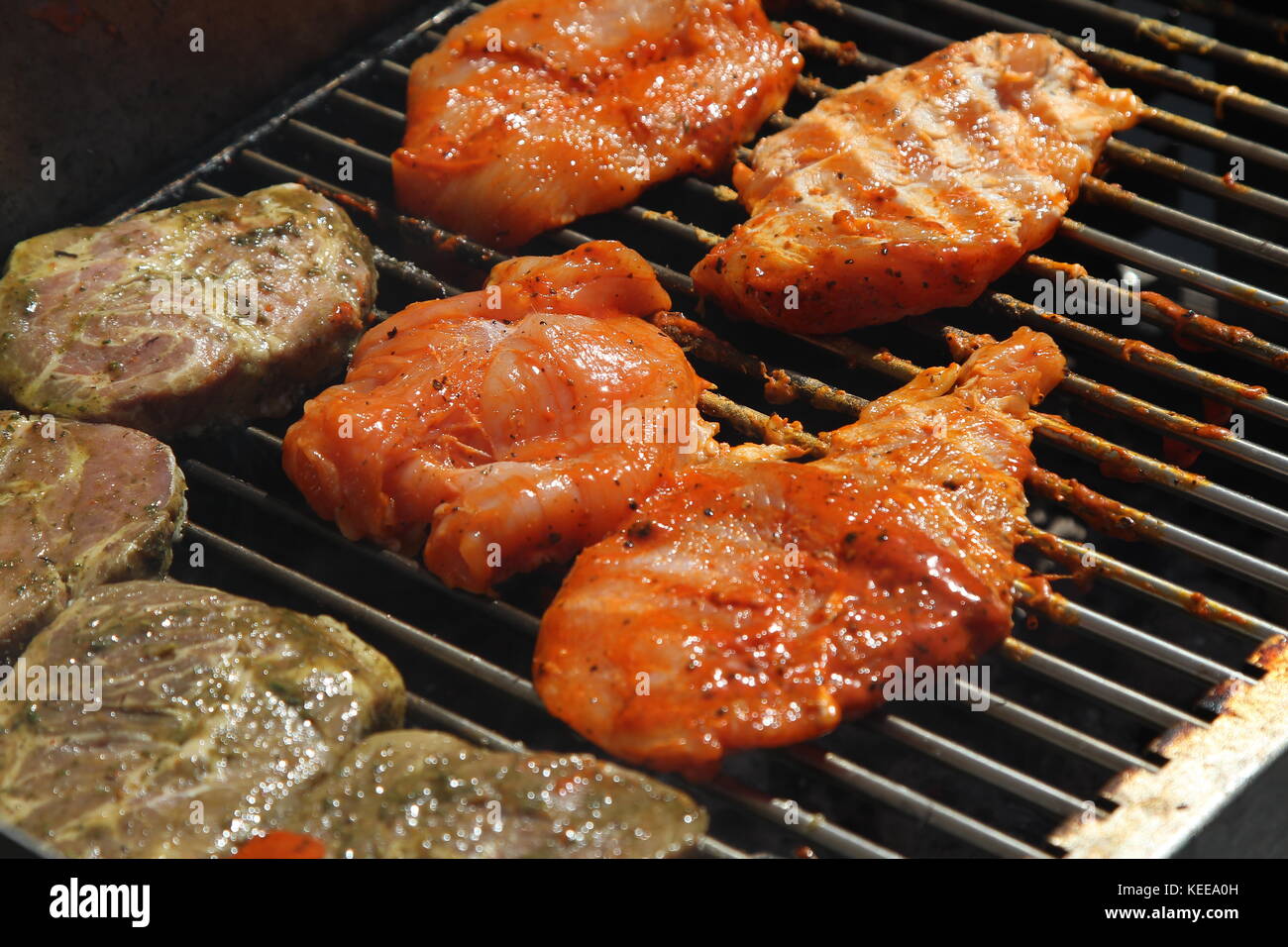 Meat fried on the grill / Meat and sausages are roasted on fire Stock ...