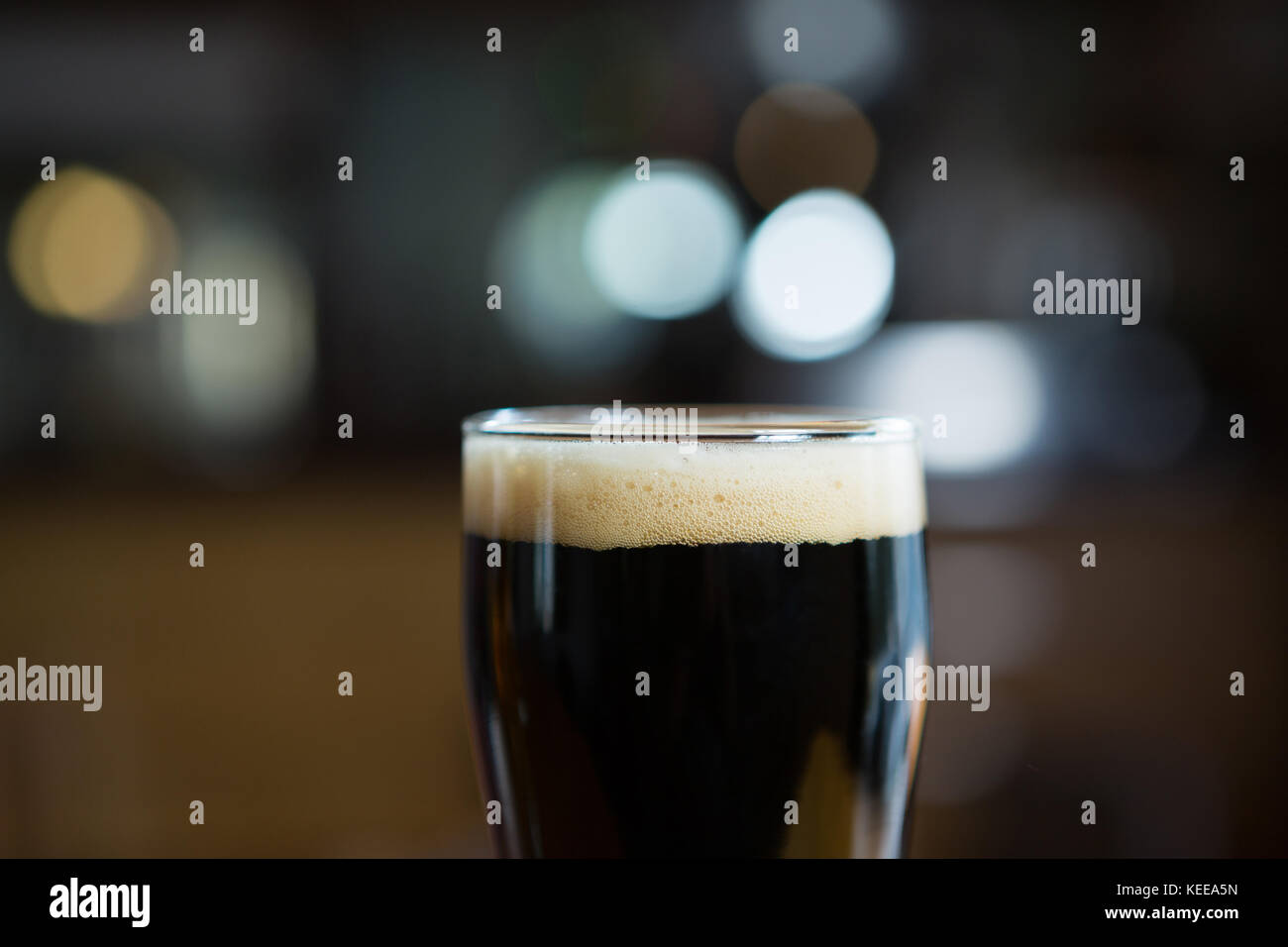 Close-up of beer glass on the counter in bar Stock Photo - Alamy