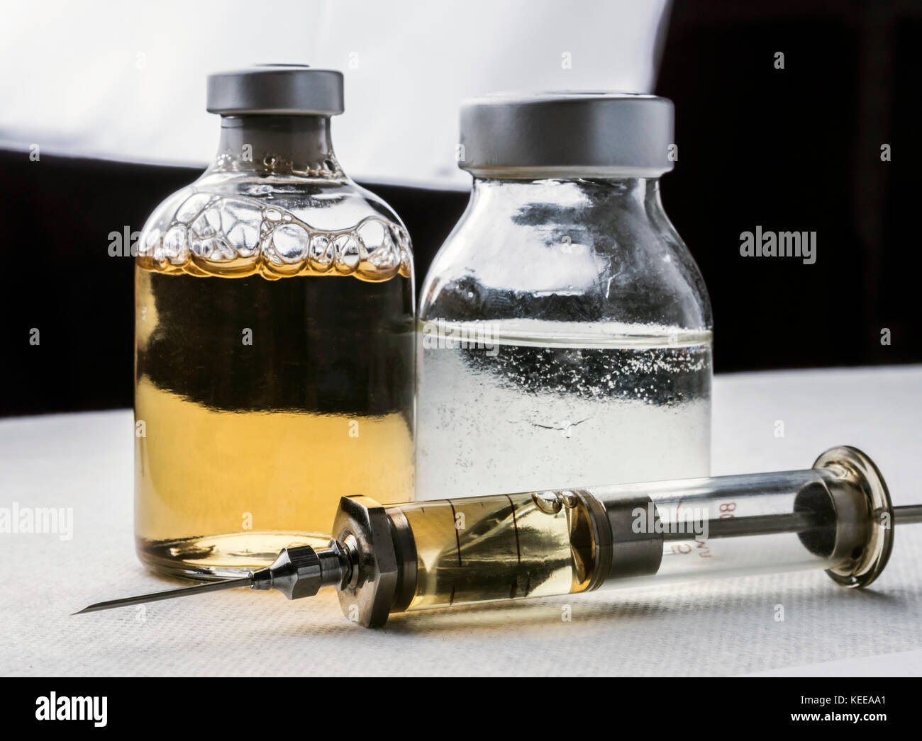 Several vials and syringe in laboratory, conceptual image Stock Photo - Alamy