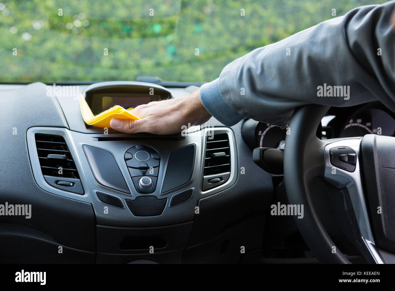 Male auto service staff cleaning car interior Stock Photo - Alamy
