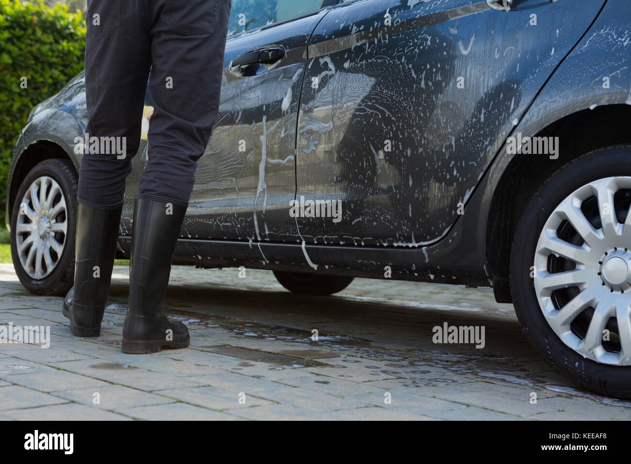 Male auto service staff washing a car Stock Photo - Alamy