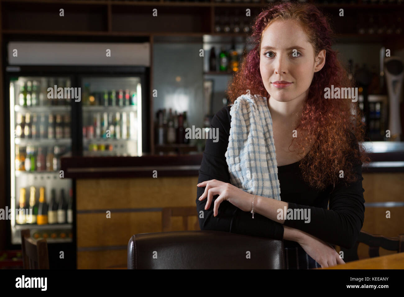 Beautiful waitress standing near bar counter Stock Photo - Alamy