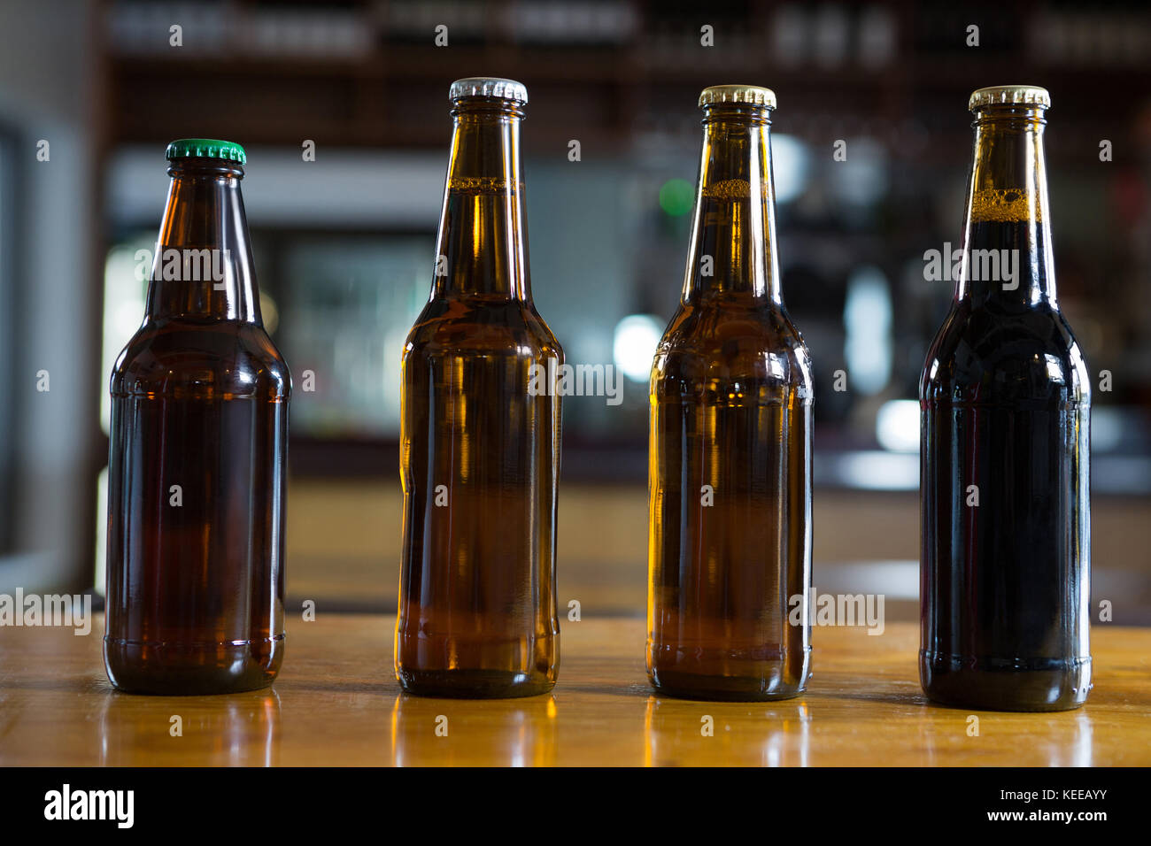 Close-up of arranged beer bottles on the bar counter at restaurant ...