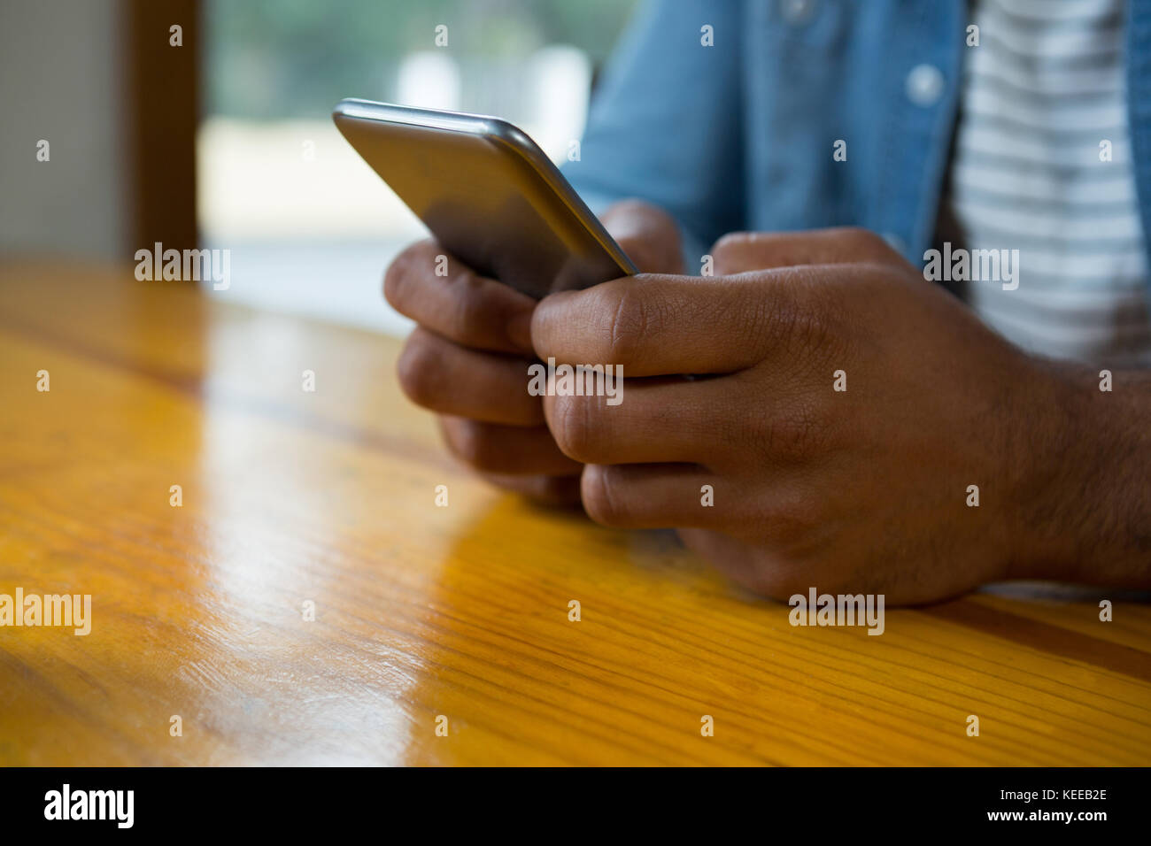 Mid-section of man using mobile phone in cafÃƒÂ© Stock Photo - Alamy