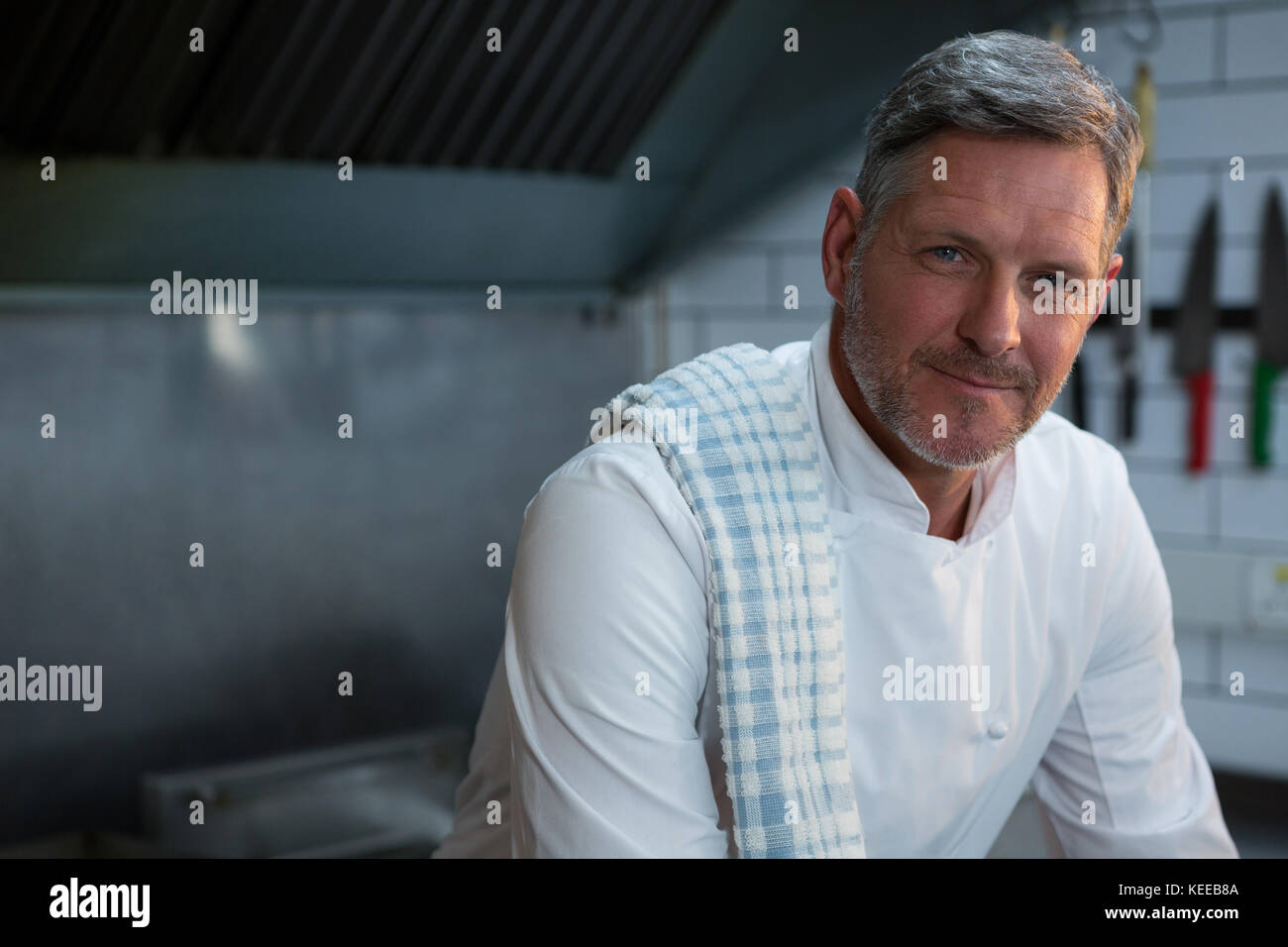 Portrait of male chef sitting in commercial kitchen Stock Photo - Alamy