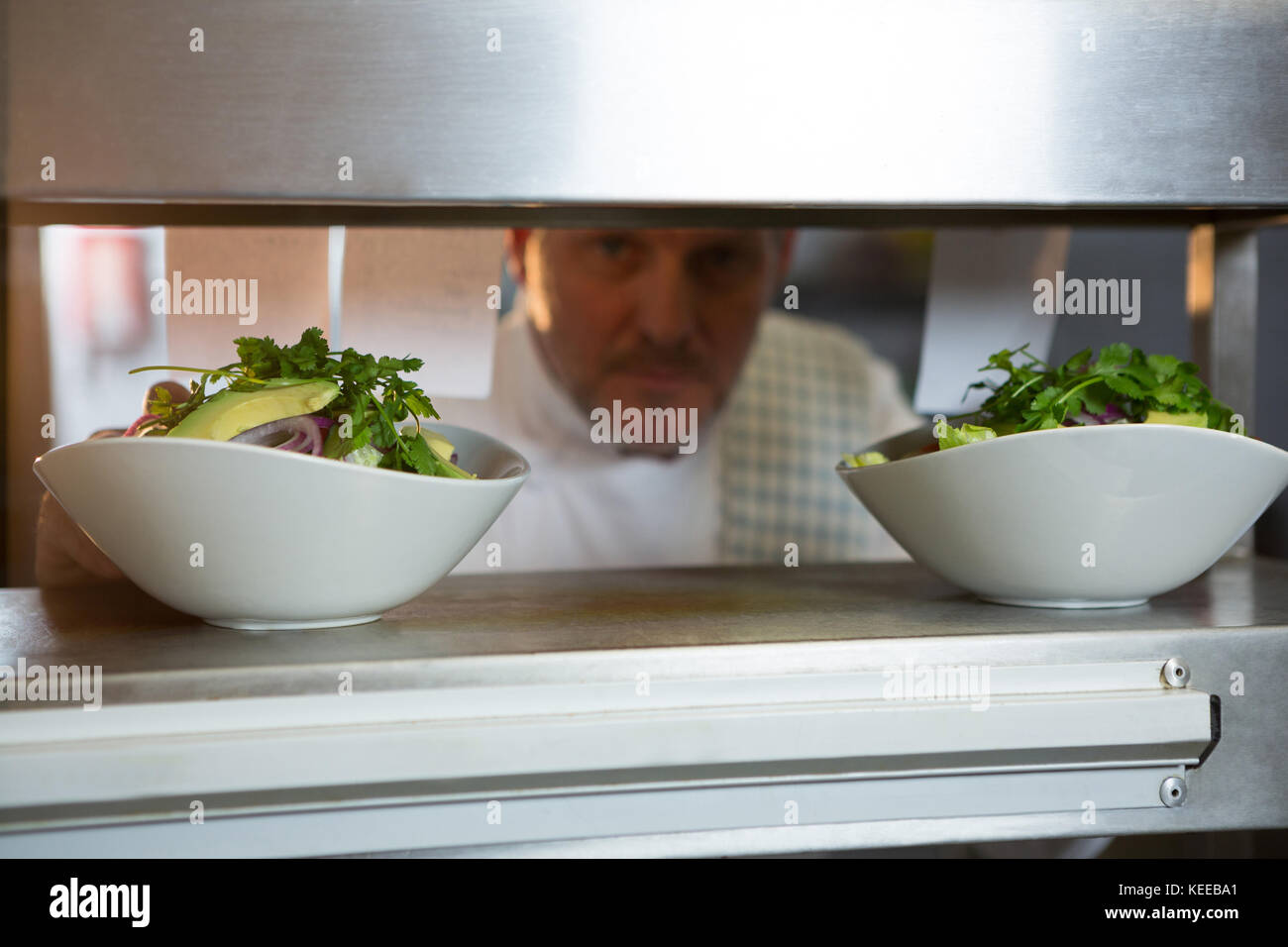 Mid section of male chef preparing meal Stock Photo - Alamy
