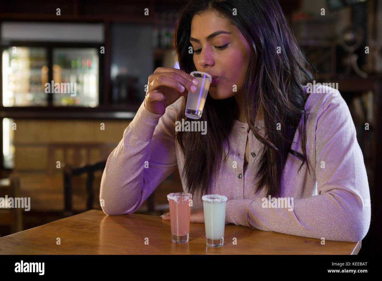 Beautiful woman drinking tequila shot Stock Photo - Alamy