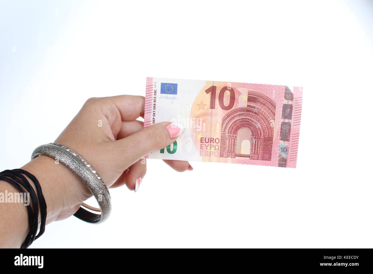 Woman hand holding euro money bill currency on isolated white cutout ...