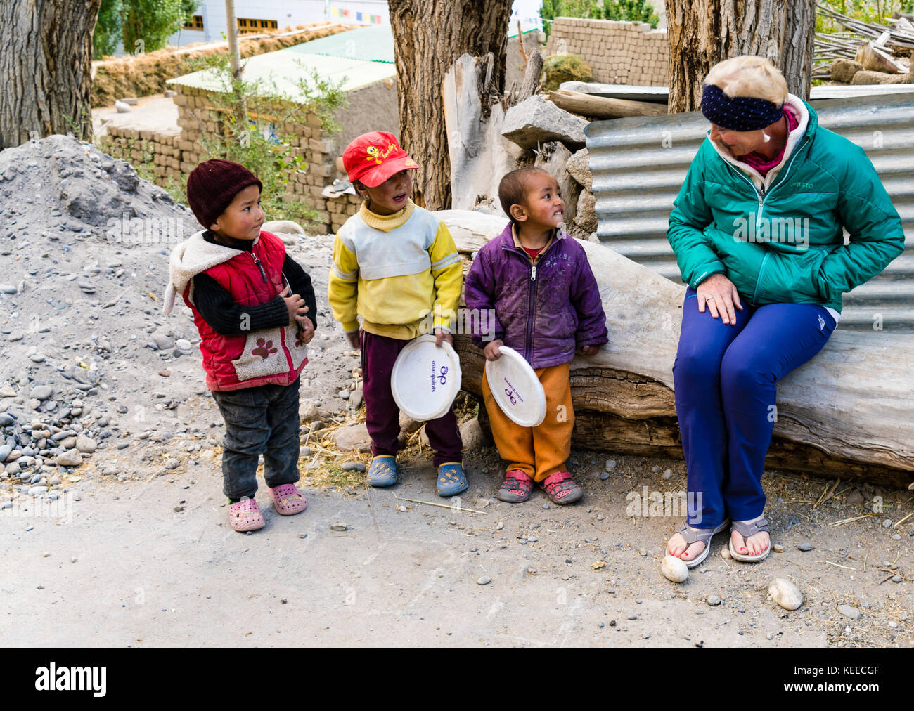 Young Ladakhi children intrigued by a Western female tourist in a ...