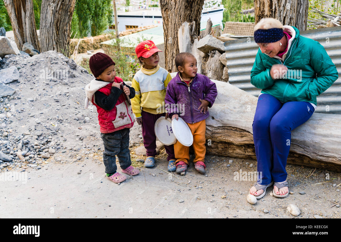 Young Ladakhi children intrigued by a Western female tourist in a ...