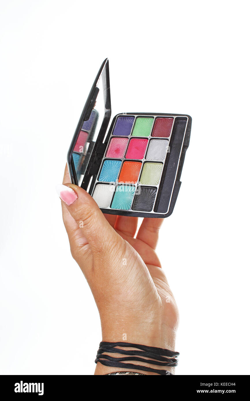 Woman hand holding makeup eyeshadow palette on isolated white cutout ...