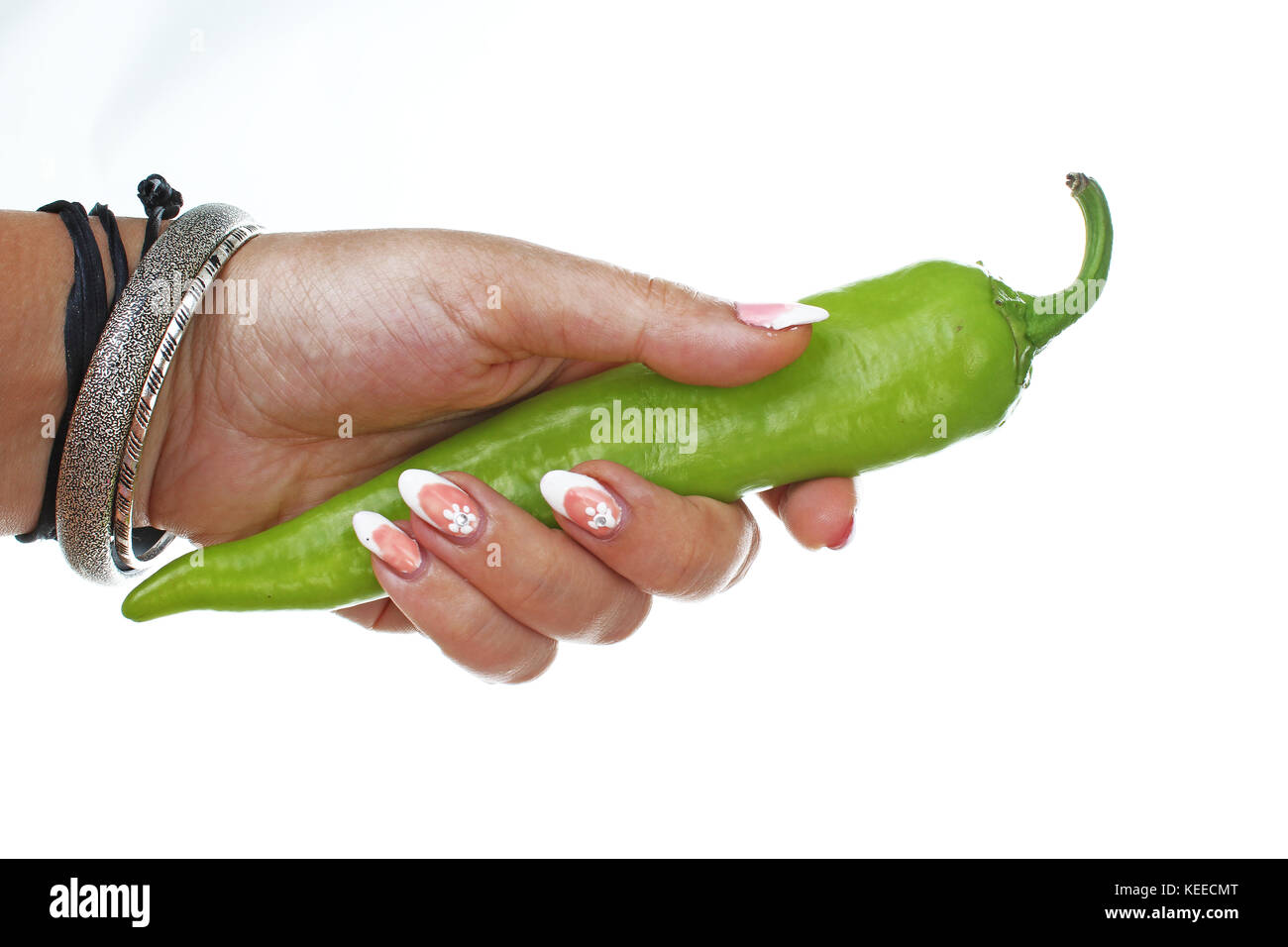 Woman hand holding hot green pepper on isolated white cutout background ...