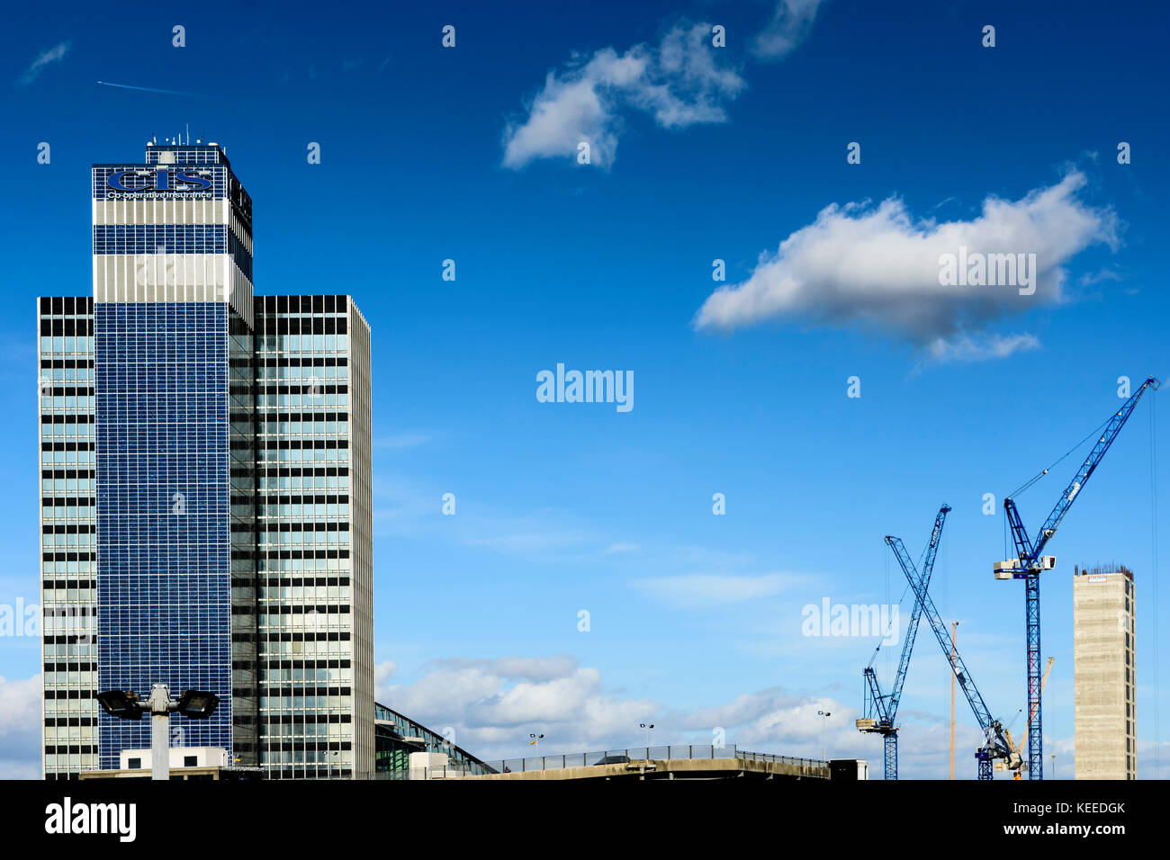 CIS Tower in Manchester with cranes and a deep blue sky, UK Stock Photo ...