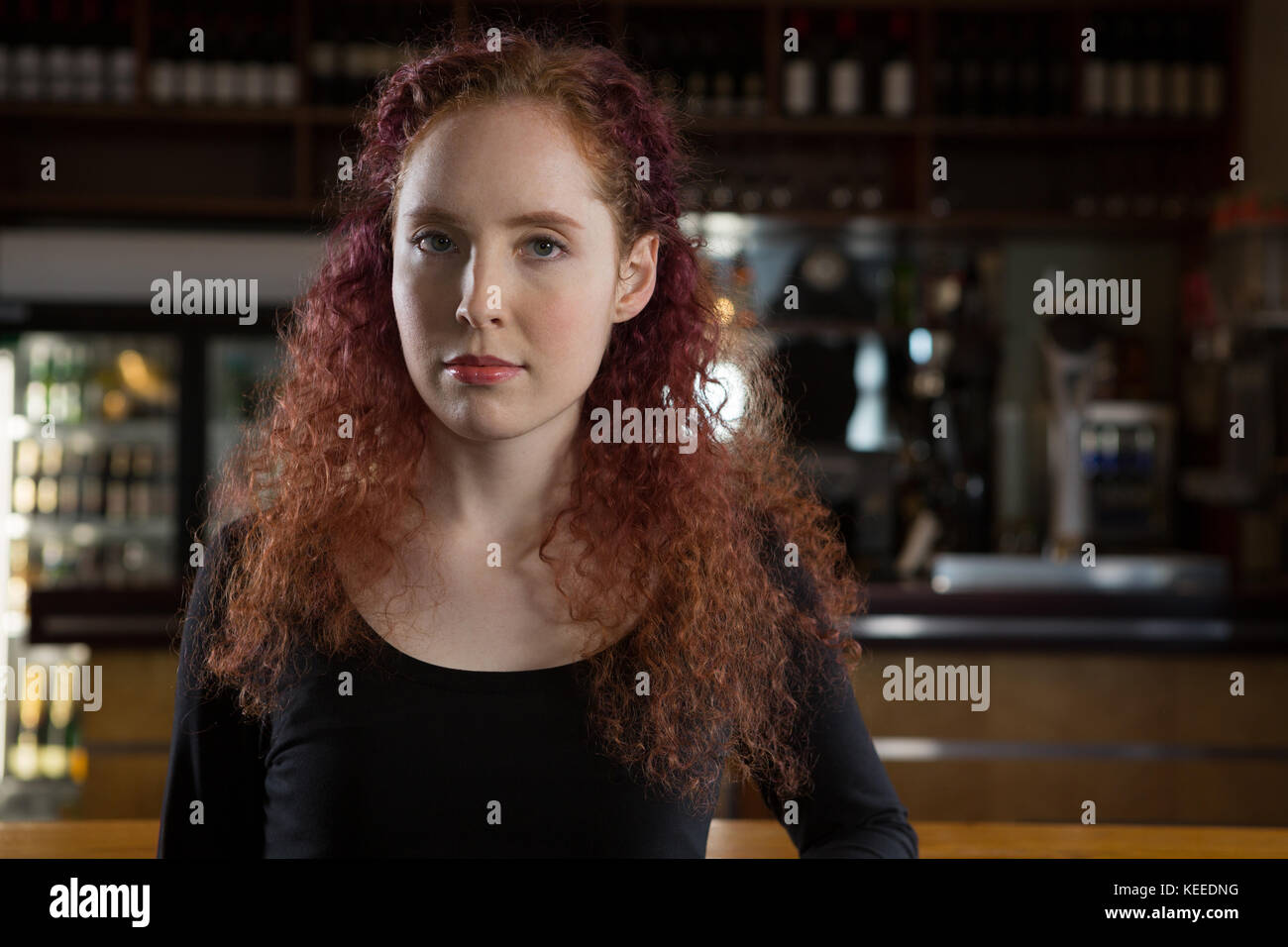 Beautiful waitress standing near bar counter Stock Photo - Alamy
