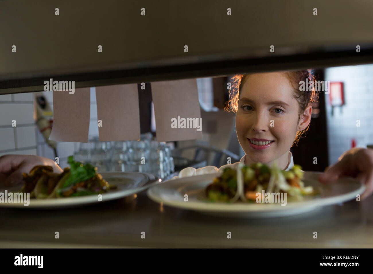 Female chef reading order hi-res stock photography and images - Alamy