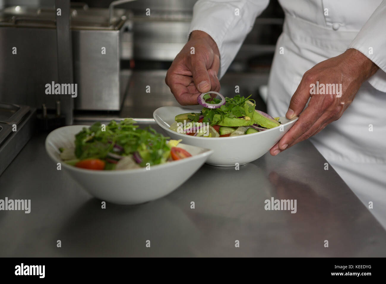 Mid section of male chef preparing meal Stock Photo - Alamy