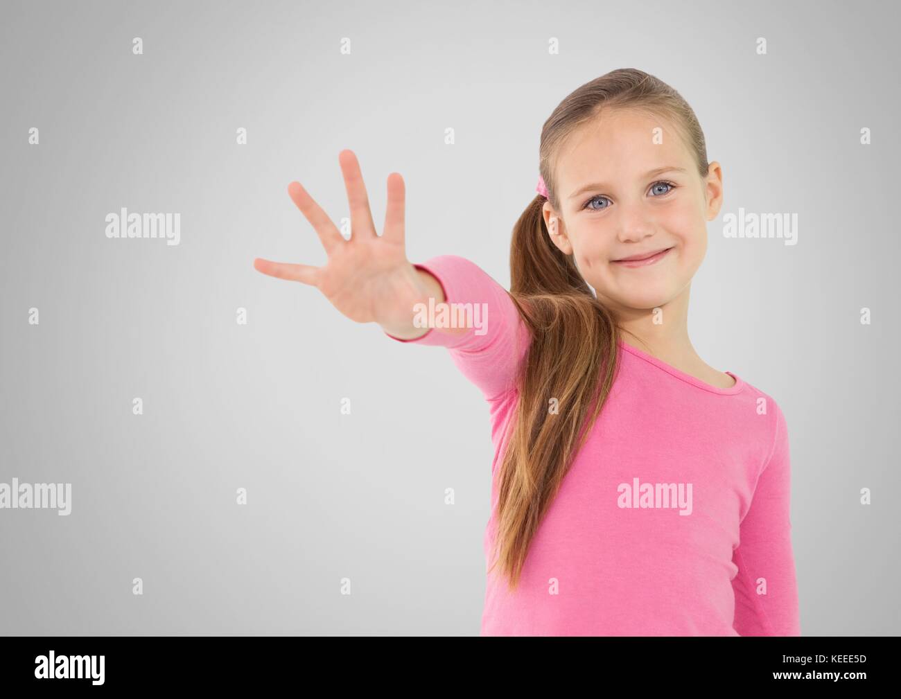 Digital composite of Girl against grey background with hand reached out ...