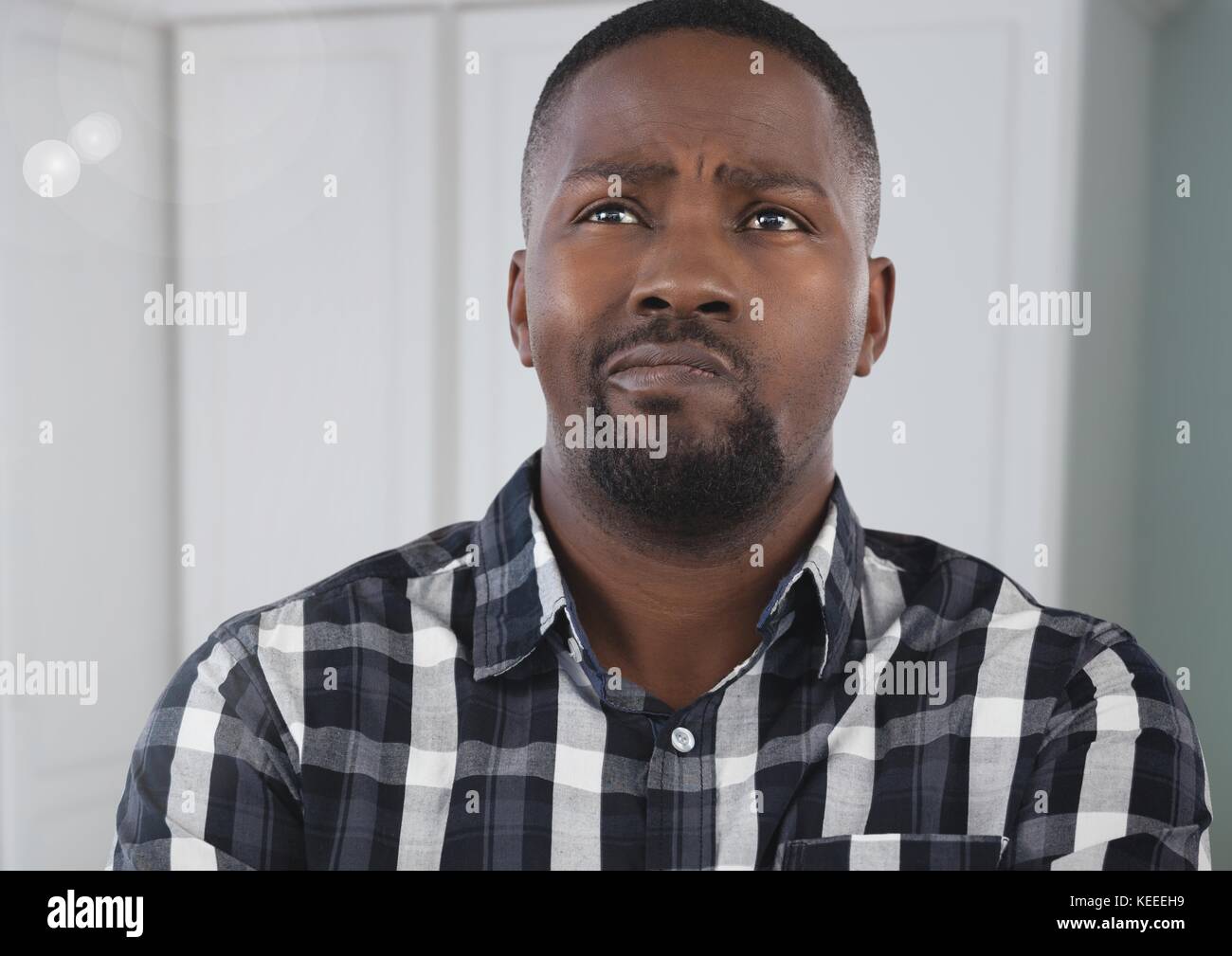 Digital composite of man thinking in room Stock Photo - Alamy