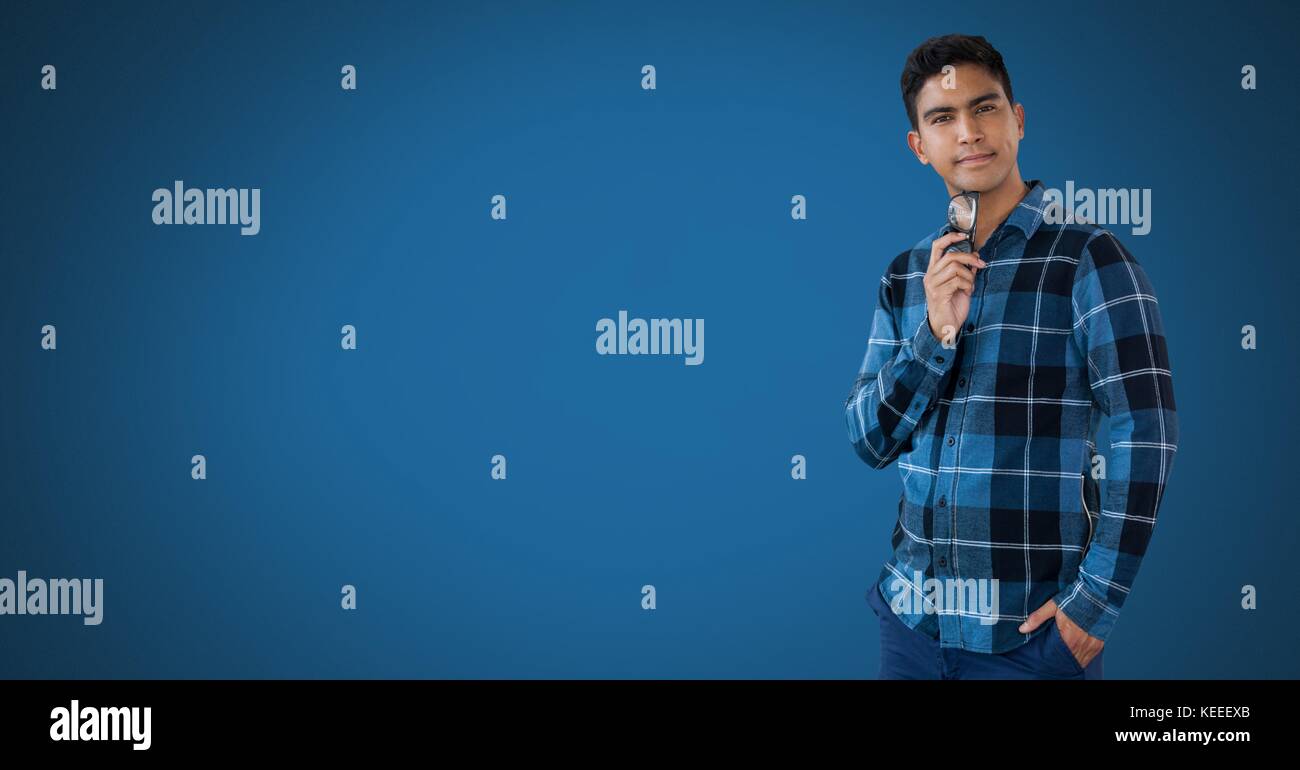 Digital composite of Businessman thinking with blue background Stock ...