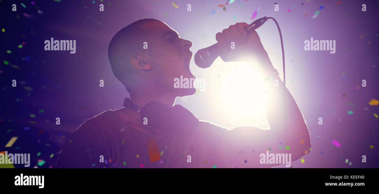 Flying colours against singer performing at illuminated nightclub Stock ...