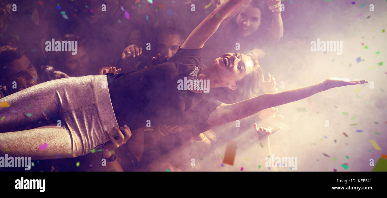 Flying colours against high angle view of crowd lifting performer at ...