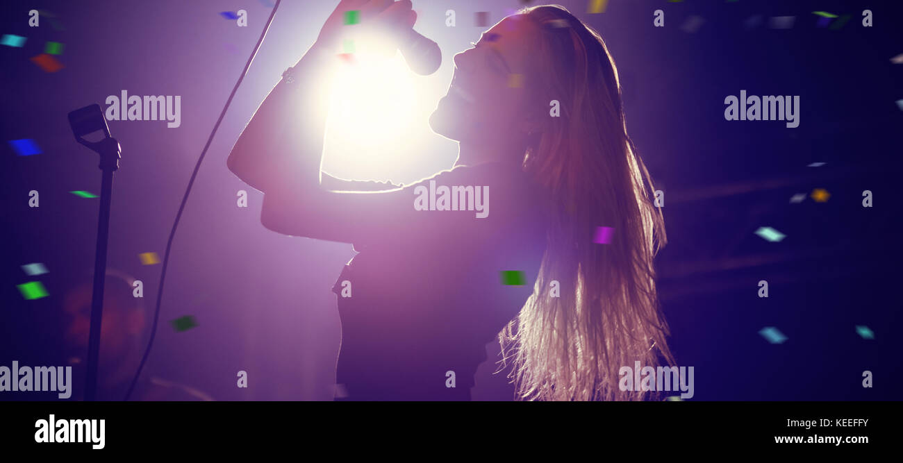Flying colours against female singer at nightclub Stock Photo - Alamy