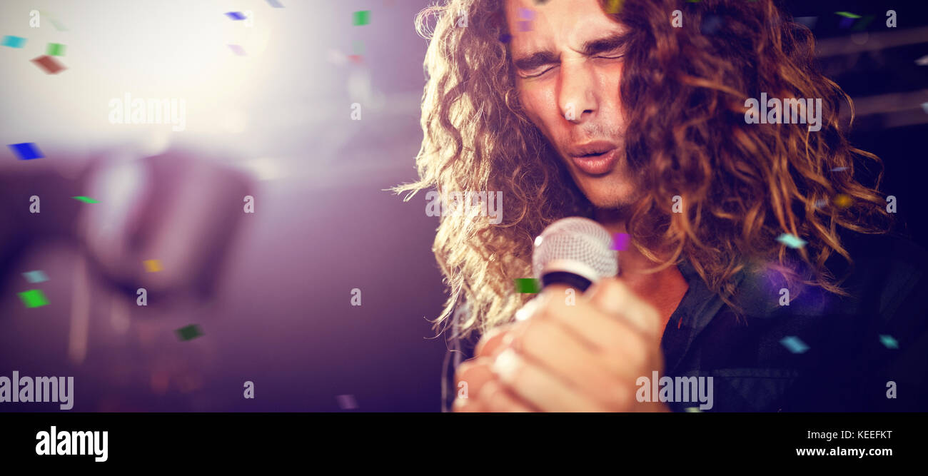 Flying colours against young male singer performing at nightclub Stock ...