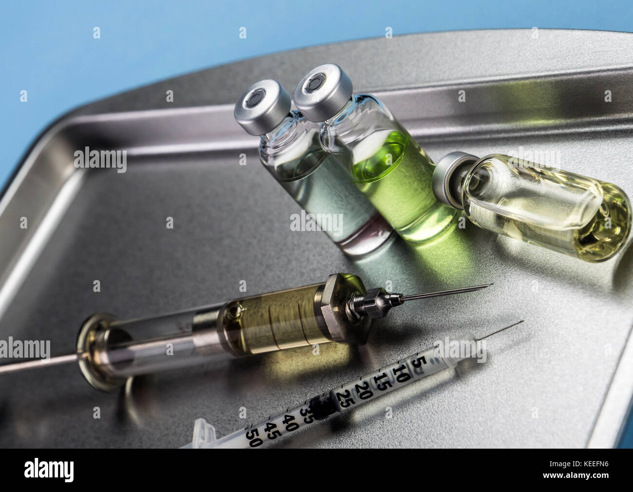 Several vials and syringe in laboratory, conceptual image Stock Photo - Alamy