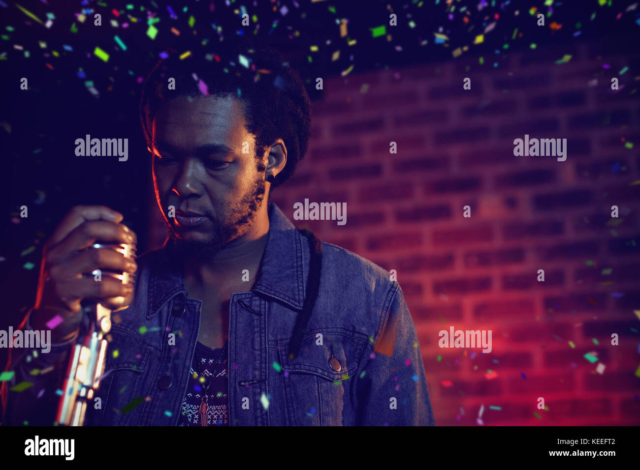 Flying colours against singer holding microphone in nightclub Stock ...