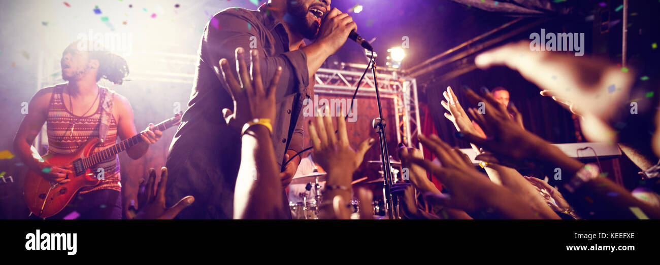 Flying colours against young singer performing on stage at nightclub ...