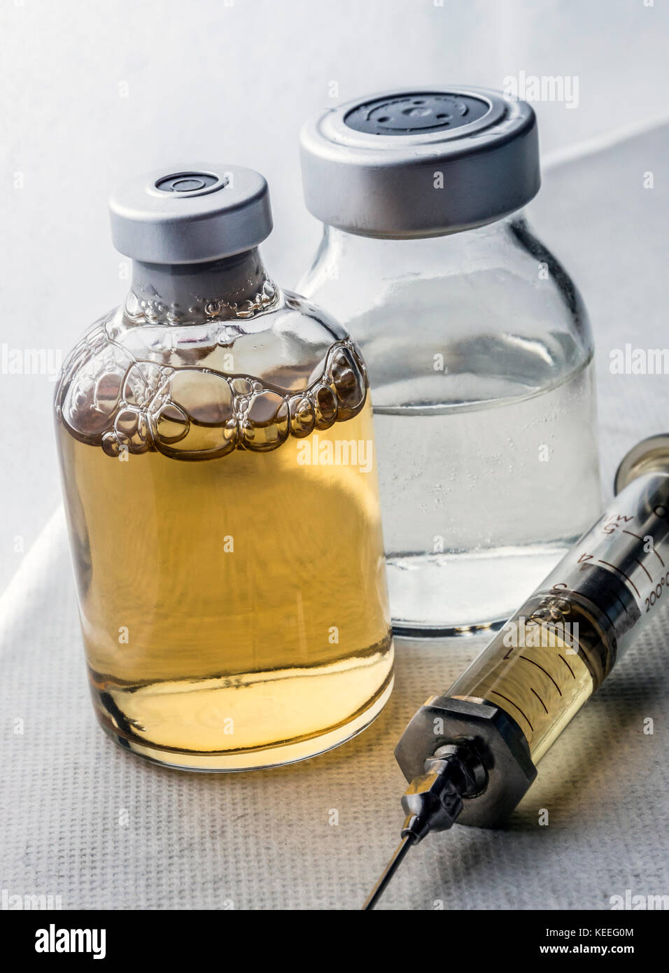 Several vials and syringe in laboratory, conceptual image Stock Photo - Alamy